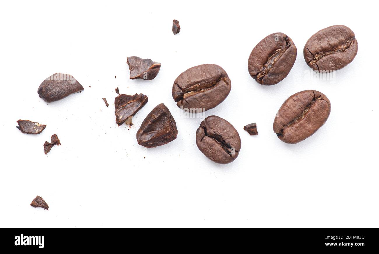 Broken roasted coffee bean with crumbs isolated on white background ...