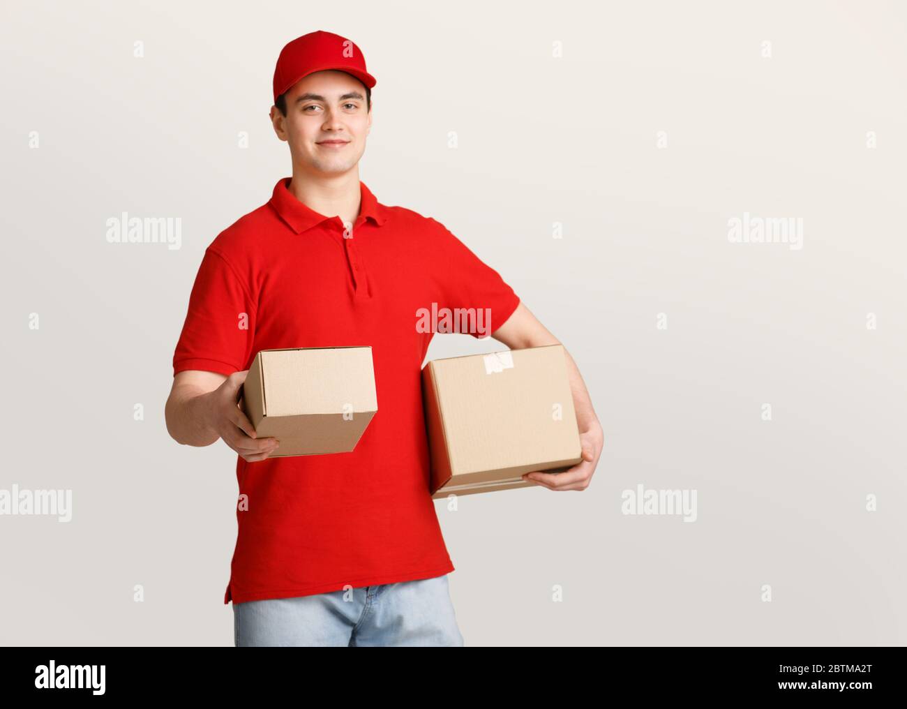 Waiting for parcel. Delivery man in uniform gives parcel at home Stock ...