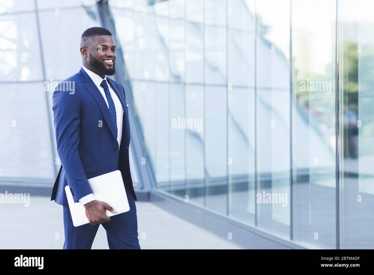 Black male walking tablet computer hi-res stock photography and images ...