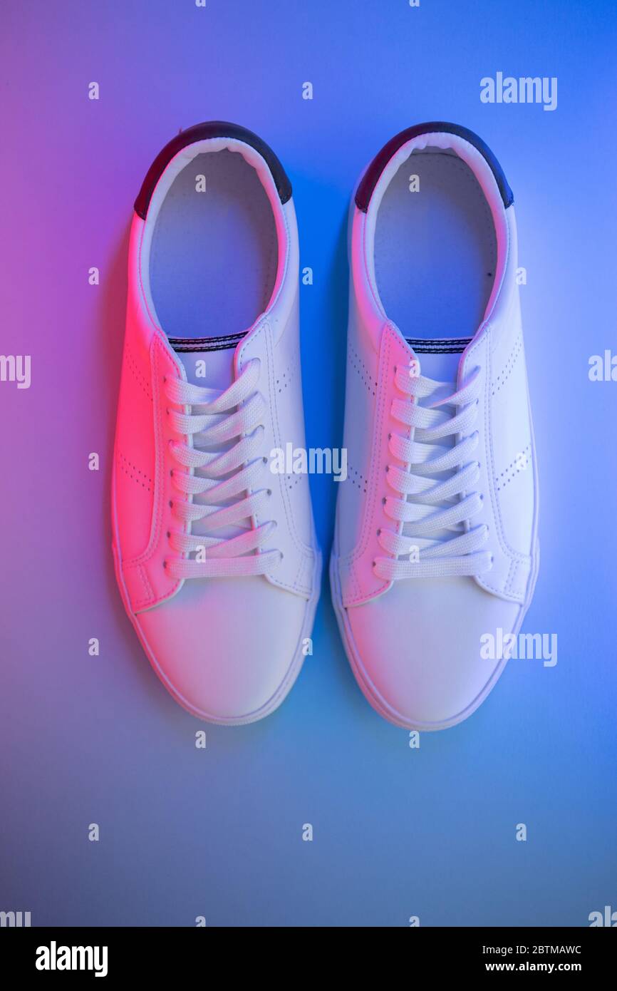 Pair of sneakers on color background, top view Stock Photo - Alamy