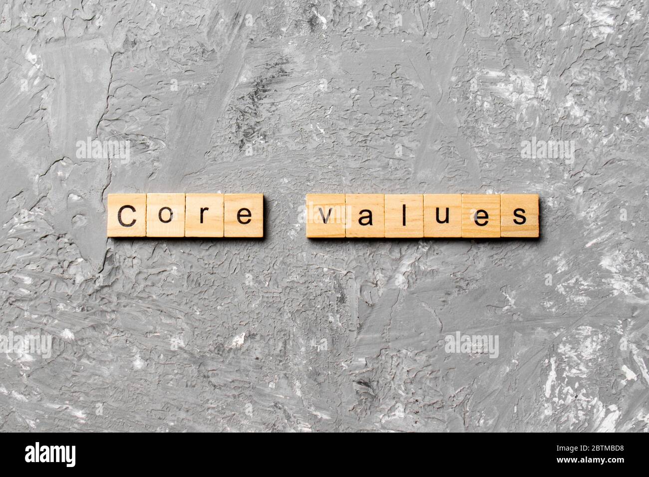 CORE VALUES word written on wood block. CORE VALUES text on cement table for your desing ...