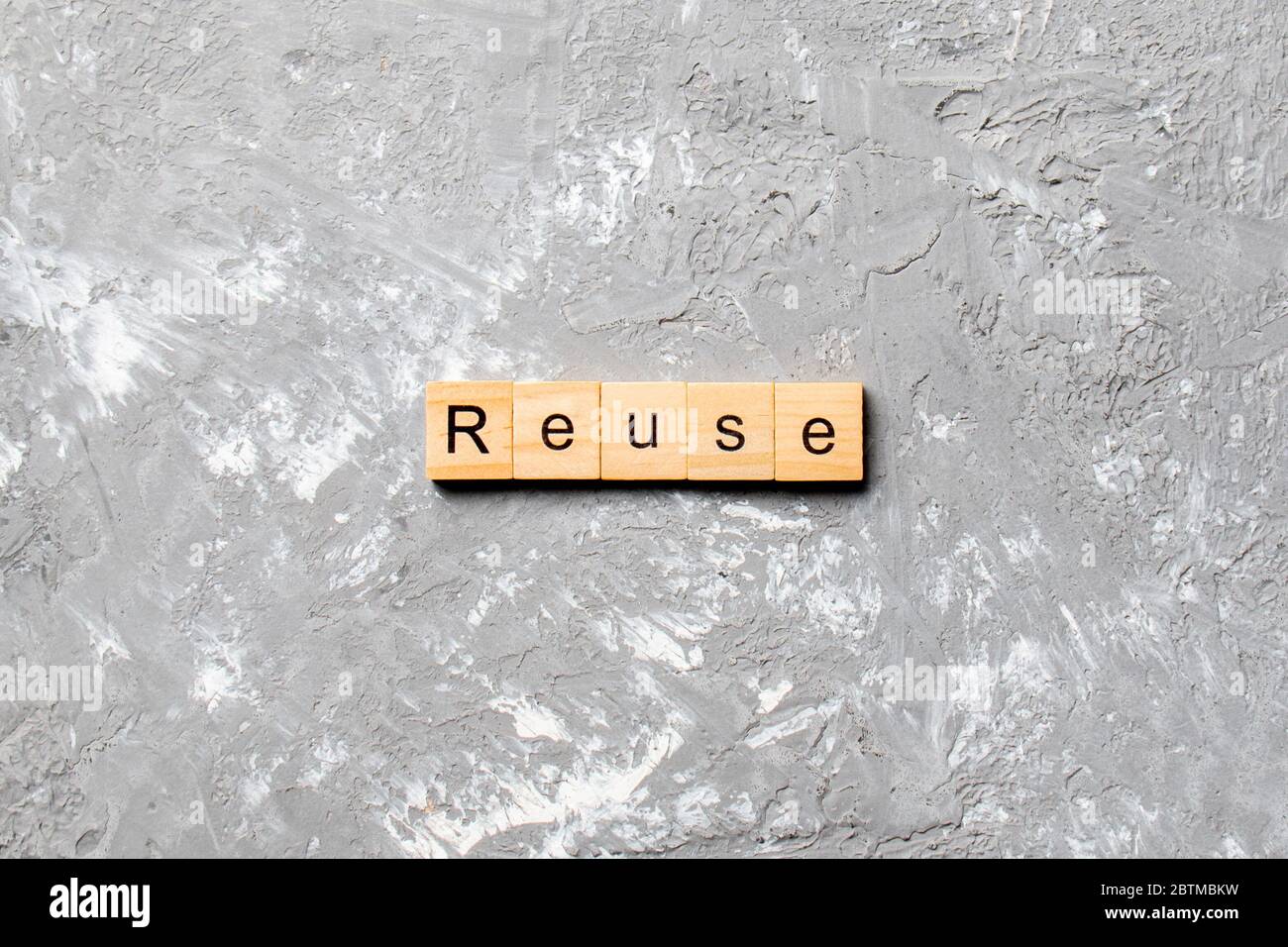 reuse word written on wood block. reuse text on cement table for your ...