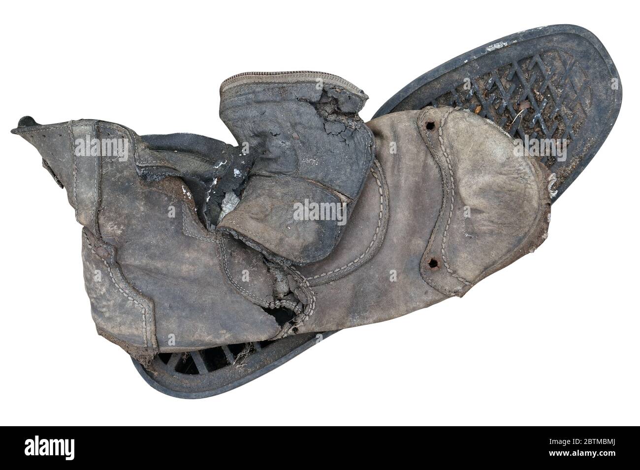 Old rotten ragged male boot lying on the road isolated on white Stock ...