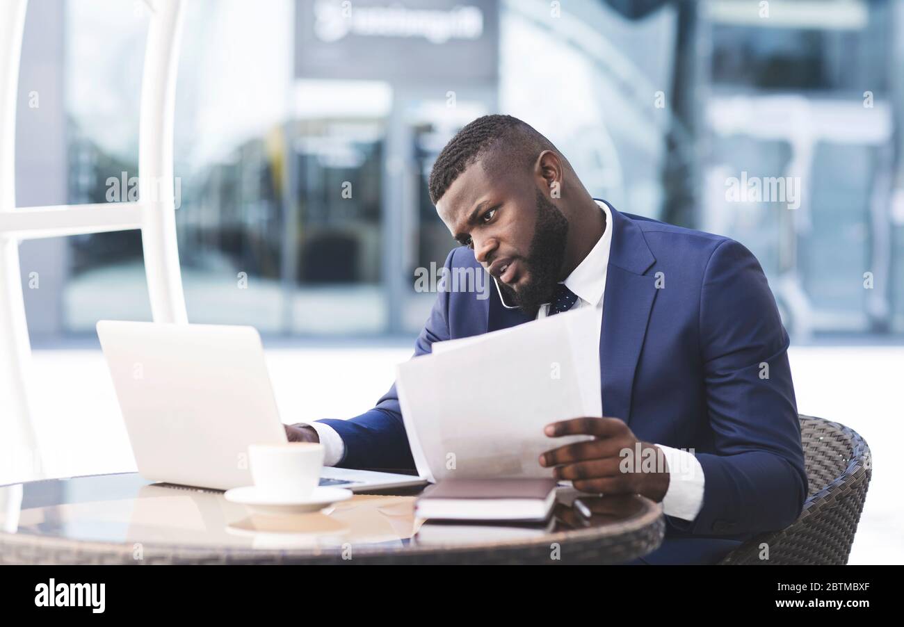 African Businessman Multitasking Talking On Phone Working Sitting In ...
