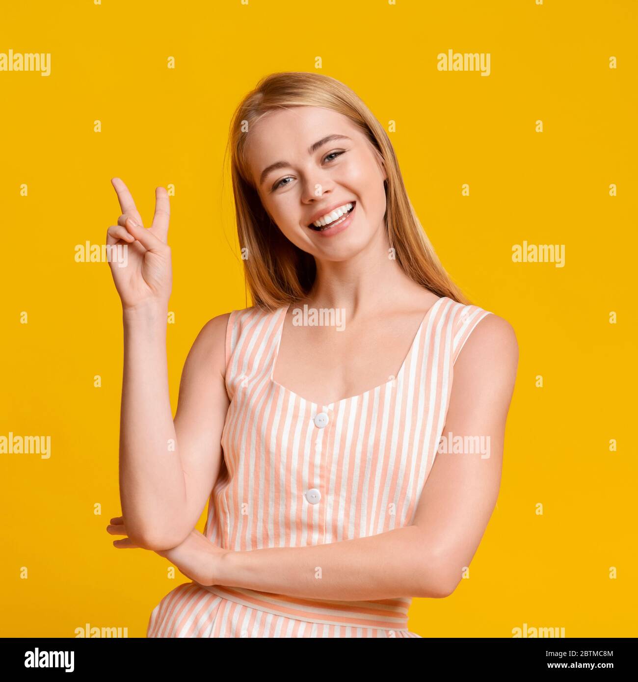 Peace. Playful Teen Girl Showing Two Fingers Gesture And Smiling Stock ...