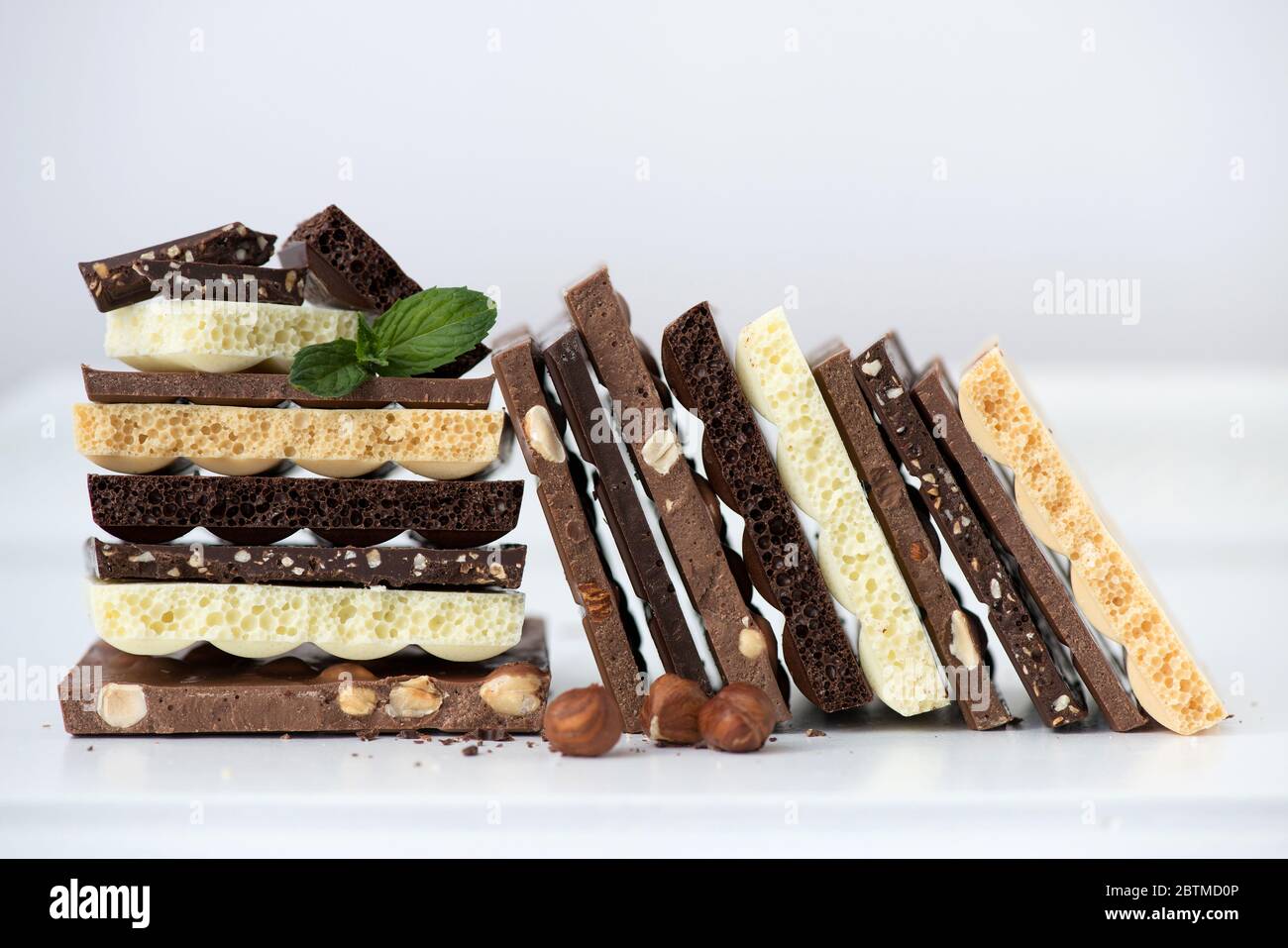 Different kinds of chocolates with nuts cocoa powder and mint ...