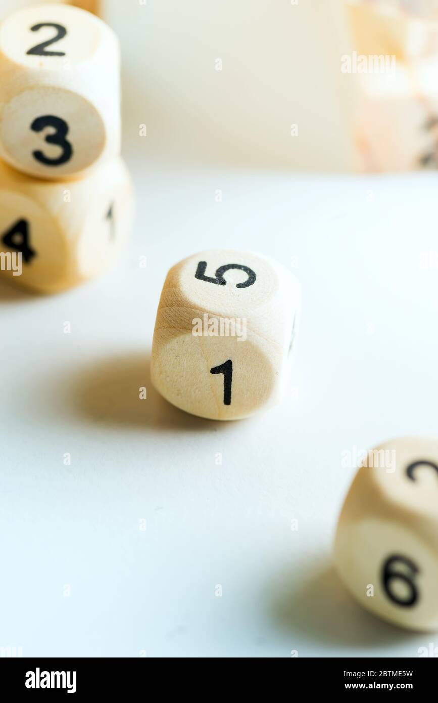 Dice game and wooden cubes with different numbers on the cube faces on ...