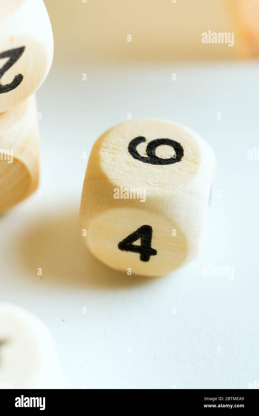 Dice game and wooden cubes with different numbers on the cube faces on ...