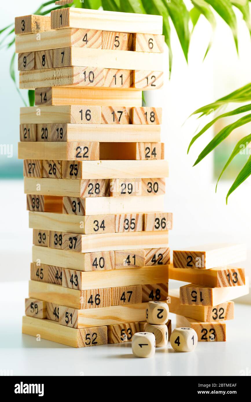 The tower from wooden blocks, game Jenga for children playing on a ...