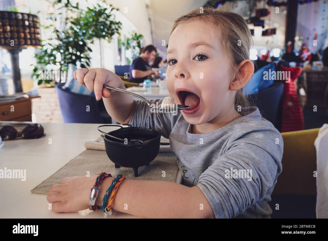 little girl eating dumpling in cafe Stock Photo - Alamy