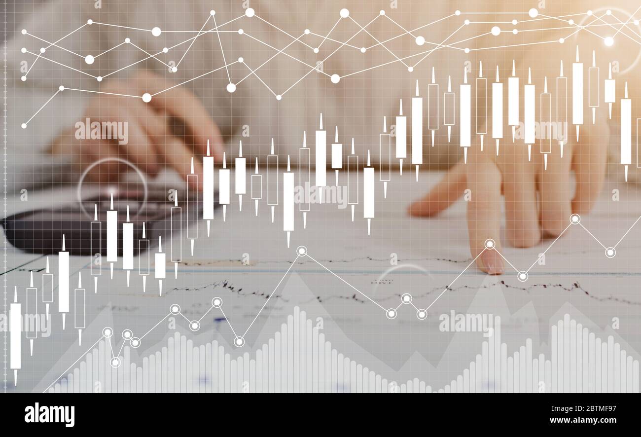 Accountant studying financial graph and making calculations at table ...