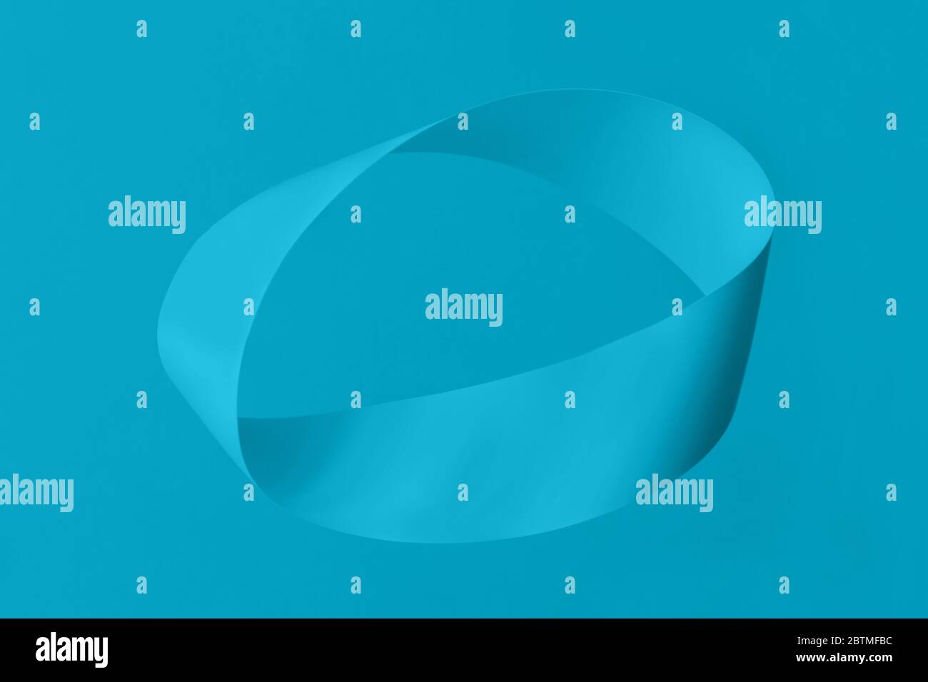 Mobius strip made from paper soaring in the air on blue mint background ...