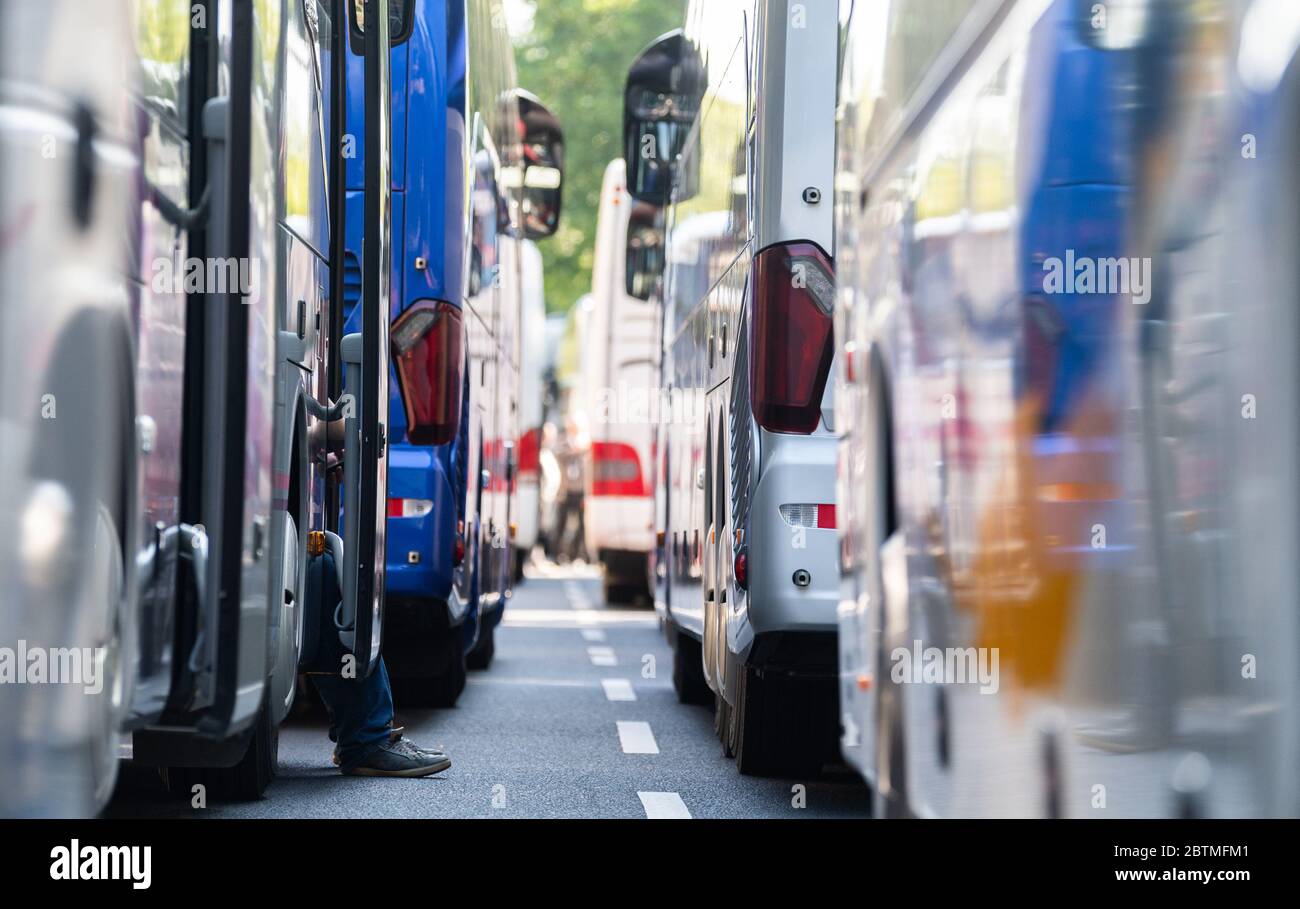 Dresden, Germany. 27th May, 2020. A bus driver sits in the door of his ...