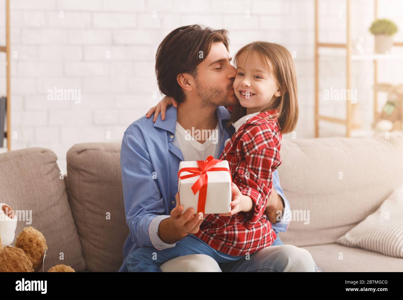 Loving little daughter giving her daddy present Stock Photo - Alamy