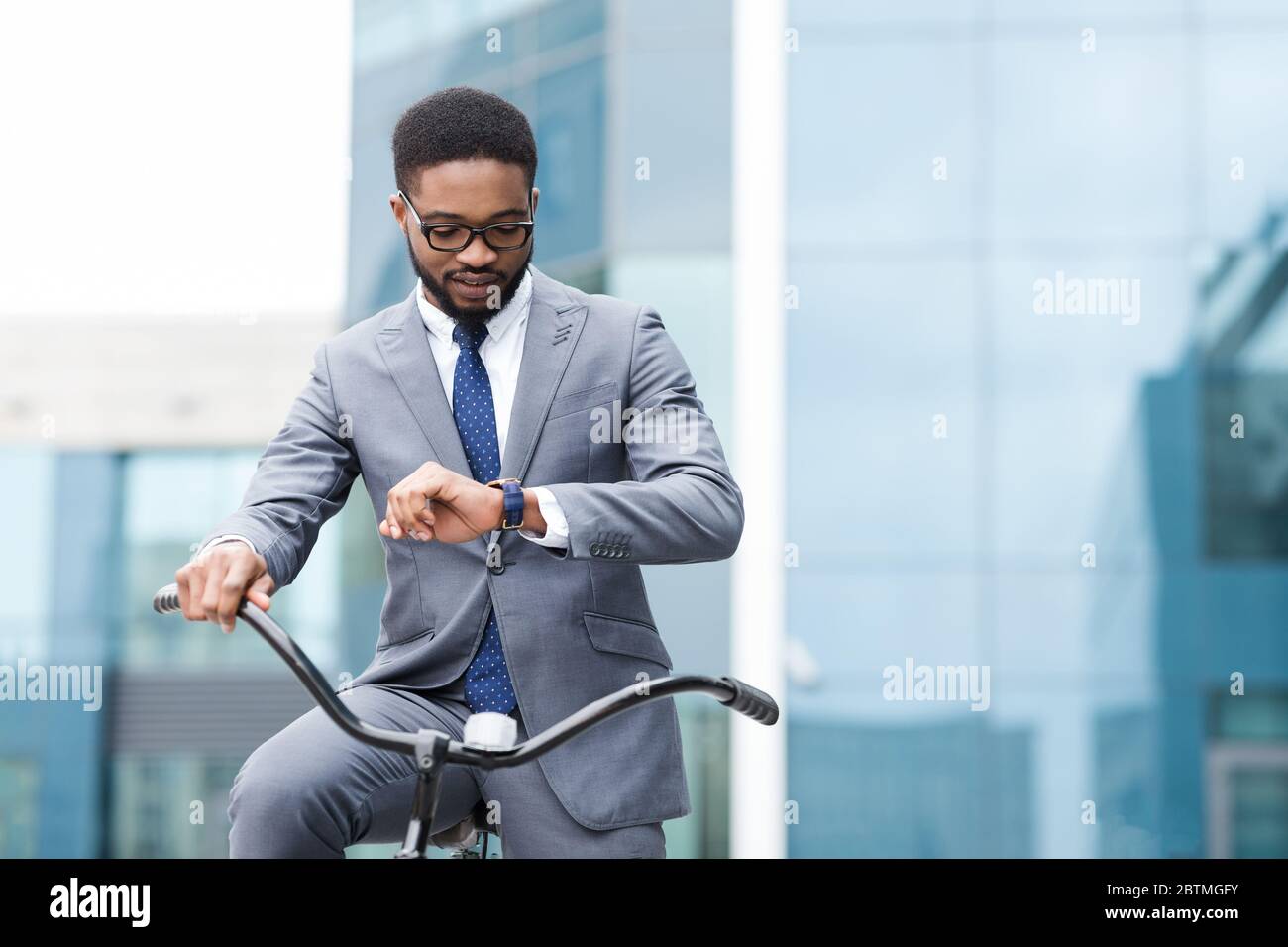 Handsome business man checking time on wristwatch Stock Photo - Alamy
