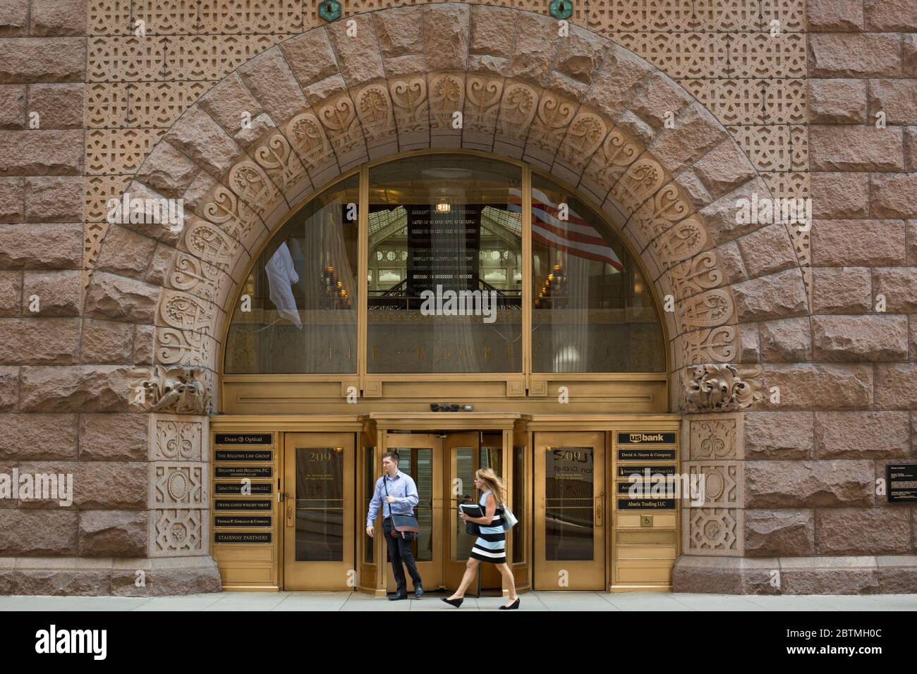 Horizontal shot of two passers-by in front of the Rookery Building ...