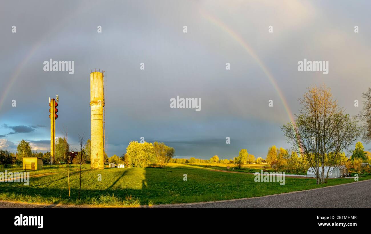 colorful panoramic view of two water towers and a rainbow Stock Photo ...