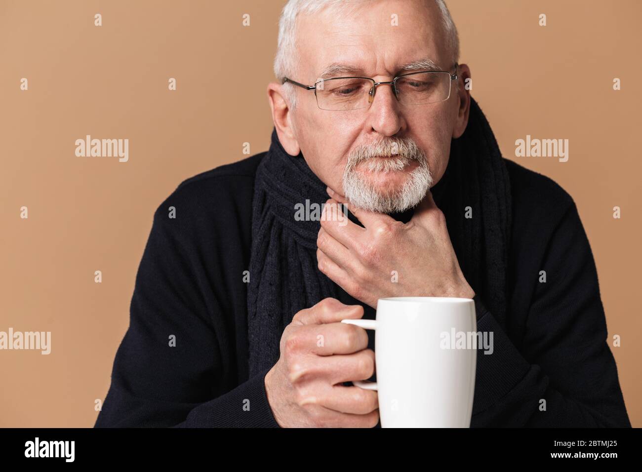 Old sick man with gray hair and beard in eyeglasses and scarf with big ...