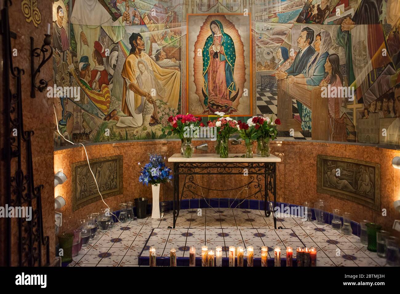 Virgin Mary chapel with candles and flowers at the interior of St Pius ...