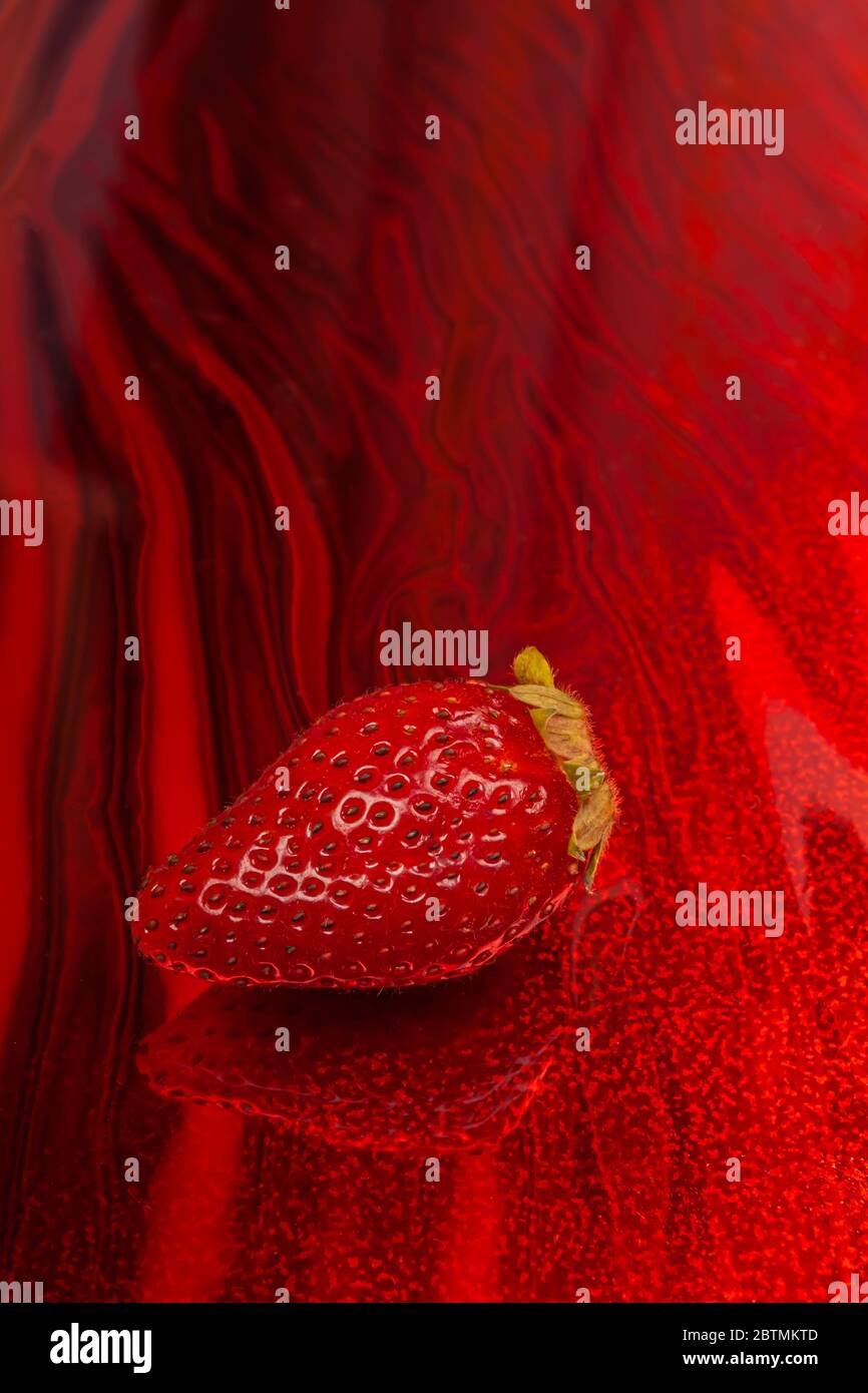 One fresh tasty strawberries on a art wavy background Stock Photo - Alamy
