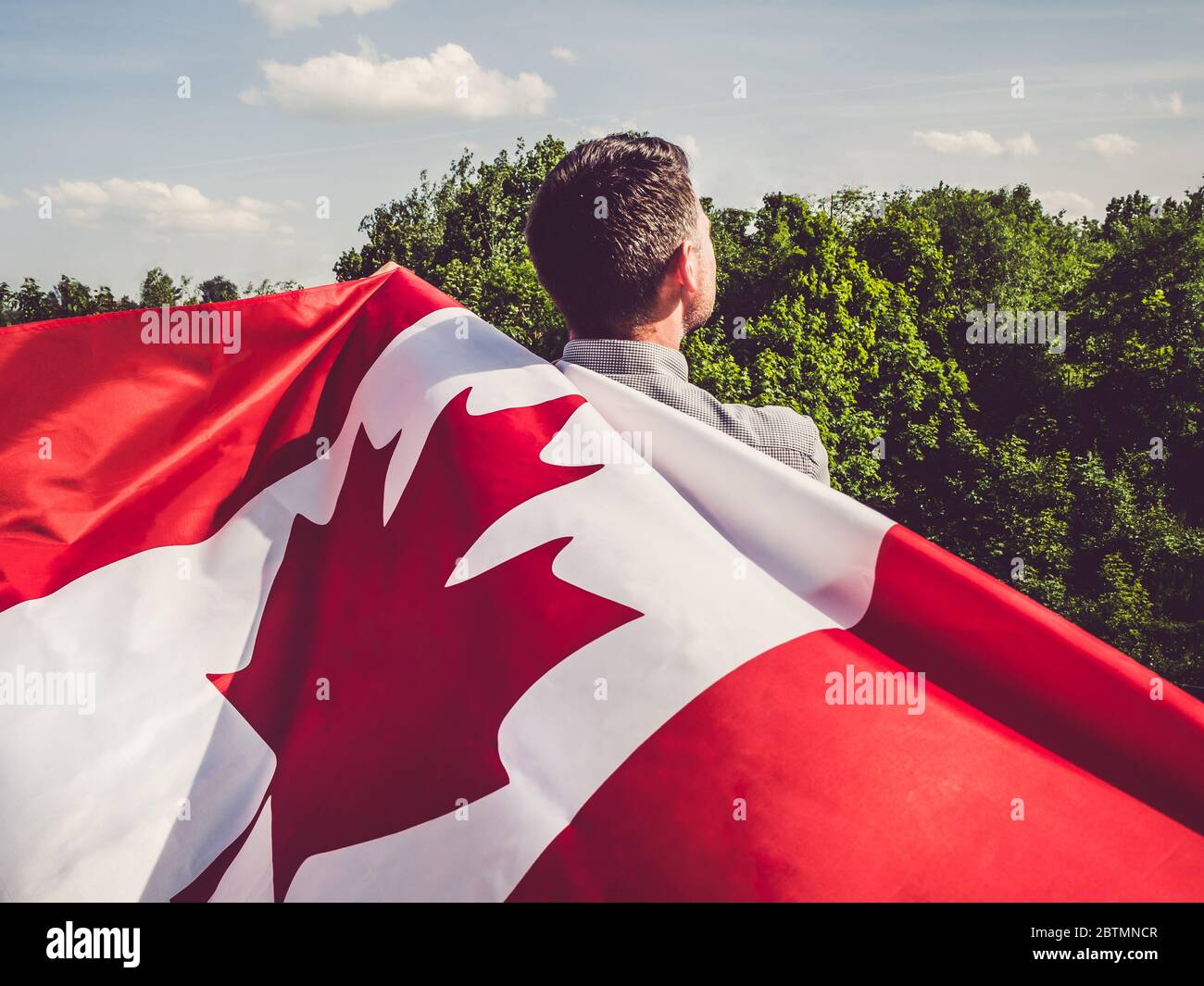 Attractive man holding Canadian Flag. National holiday Stock Photo - Alamy
