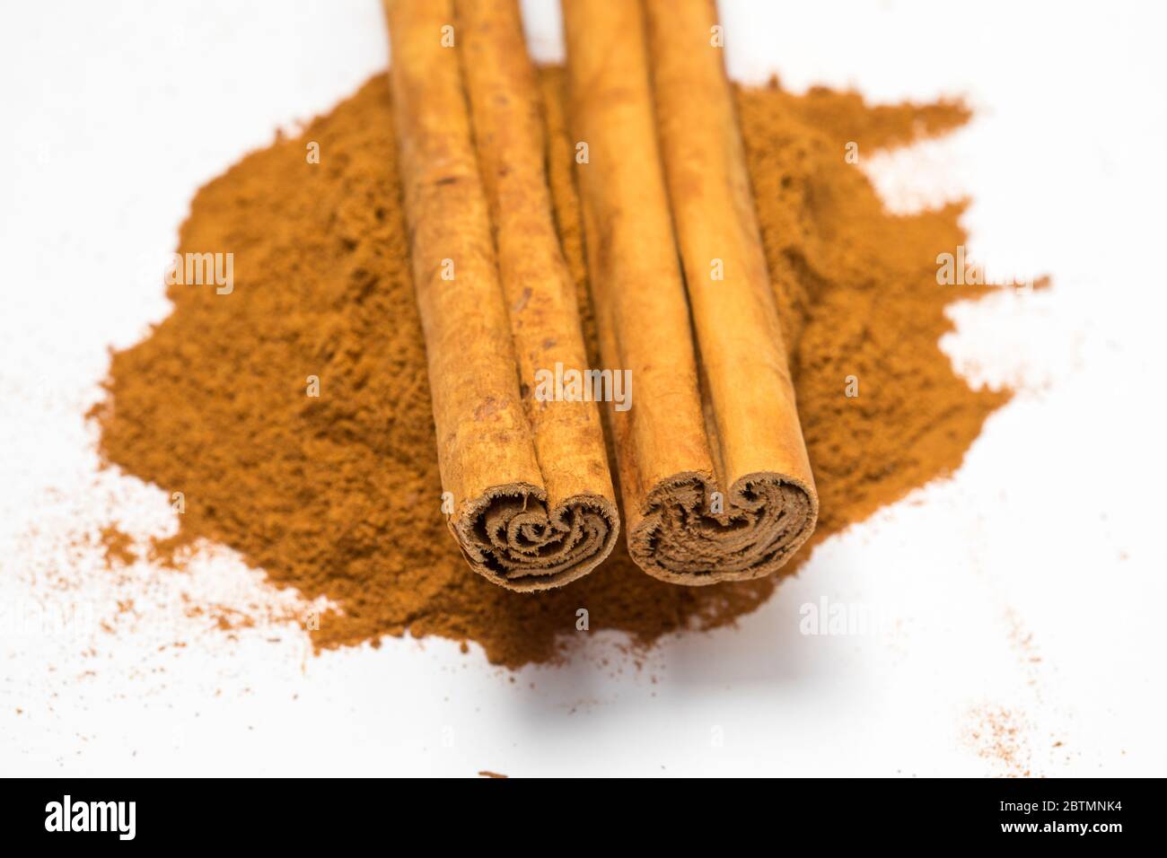 Close-up view of cinnamon sticks and powder on white background Stock ...