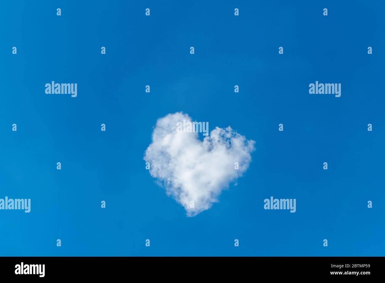 Romantic cloud in the shape of a heart on a blue sky. Love concept ...