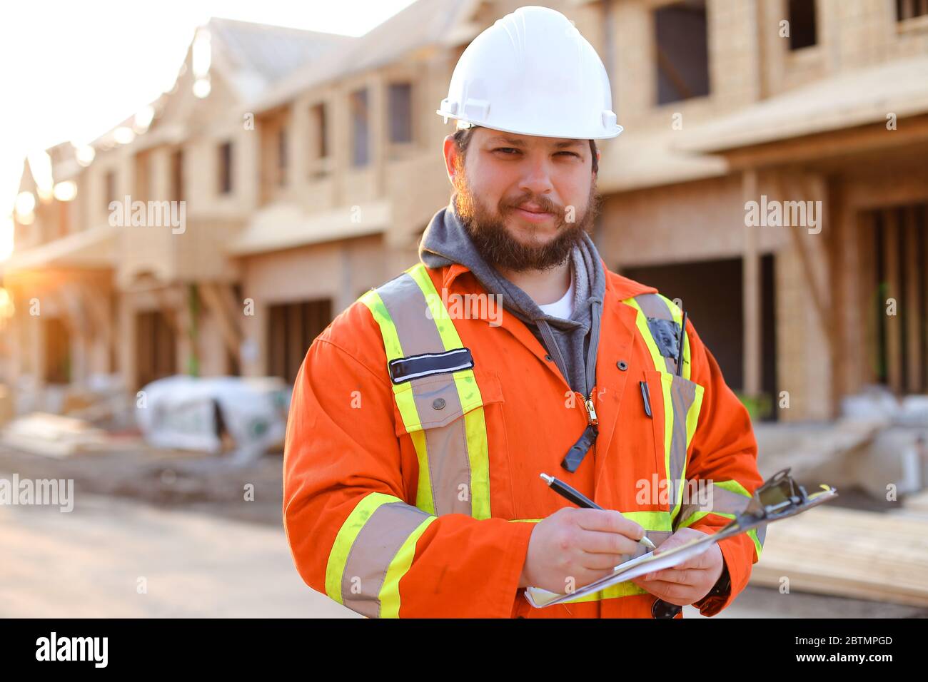 European architect writing in notebook on construction site Stock Photo ...