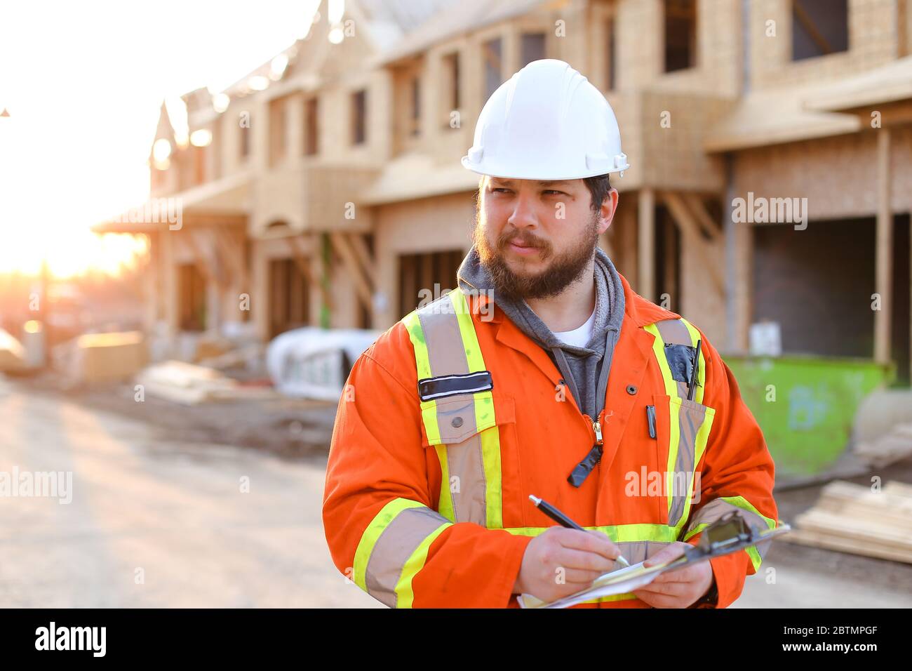 Engineer writing in notebook on construction site Stock Photo - Alamy