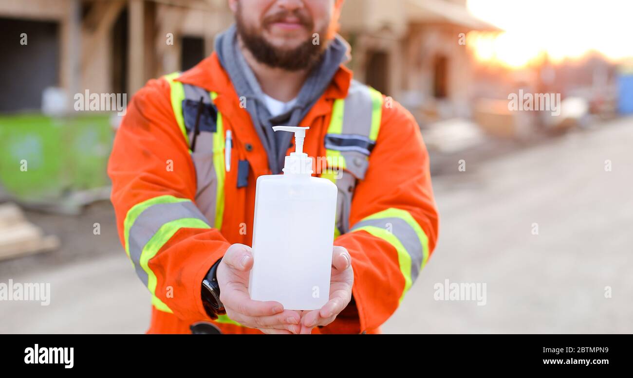 Banner of focus on disinfectant soap given by engineer at construction ...