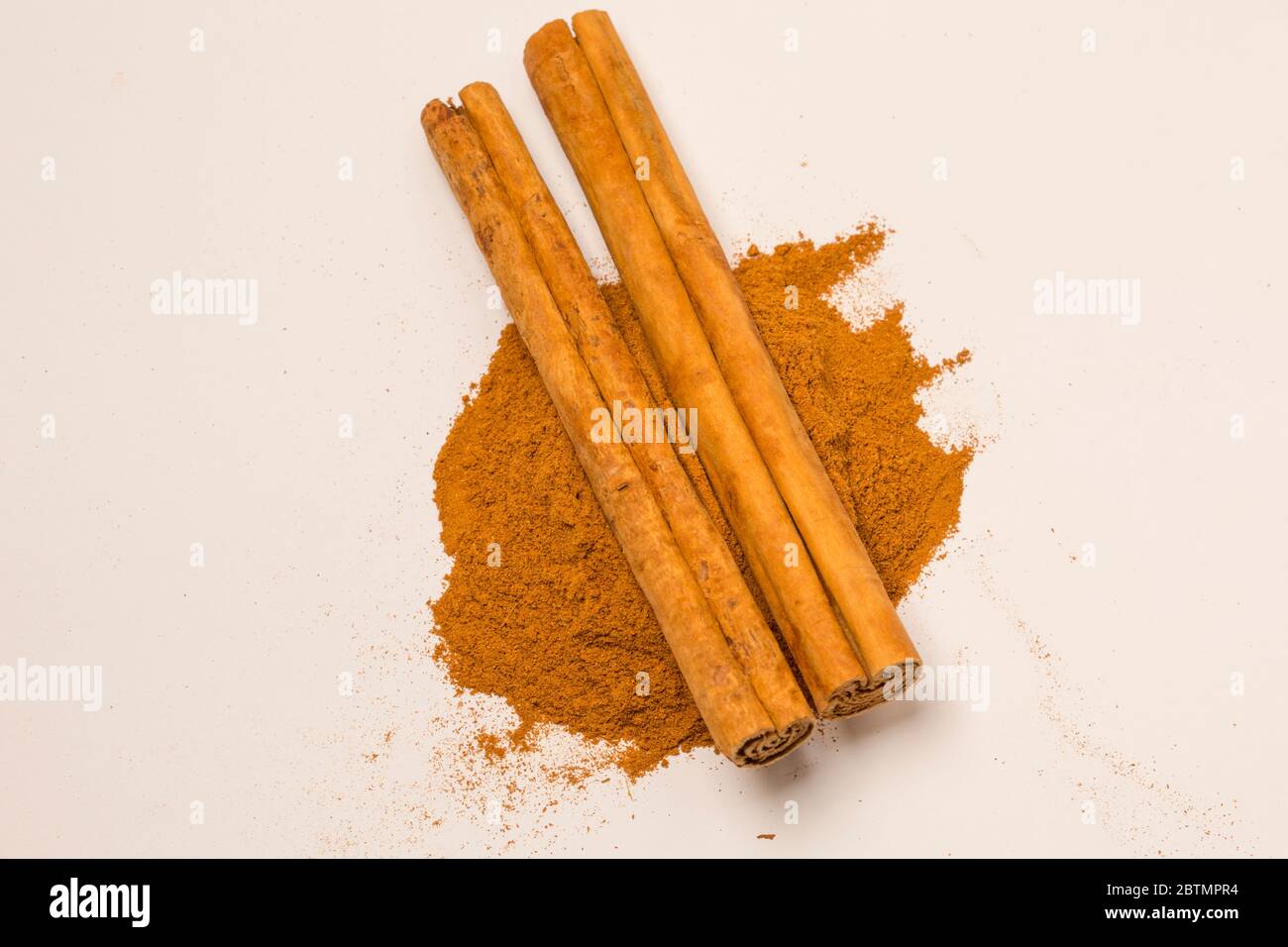Close-up view of cinnamon sticks and powder on white background Stock ...