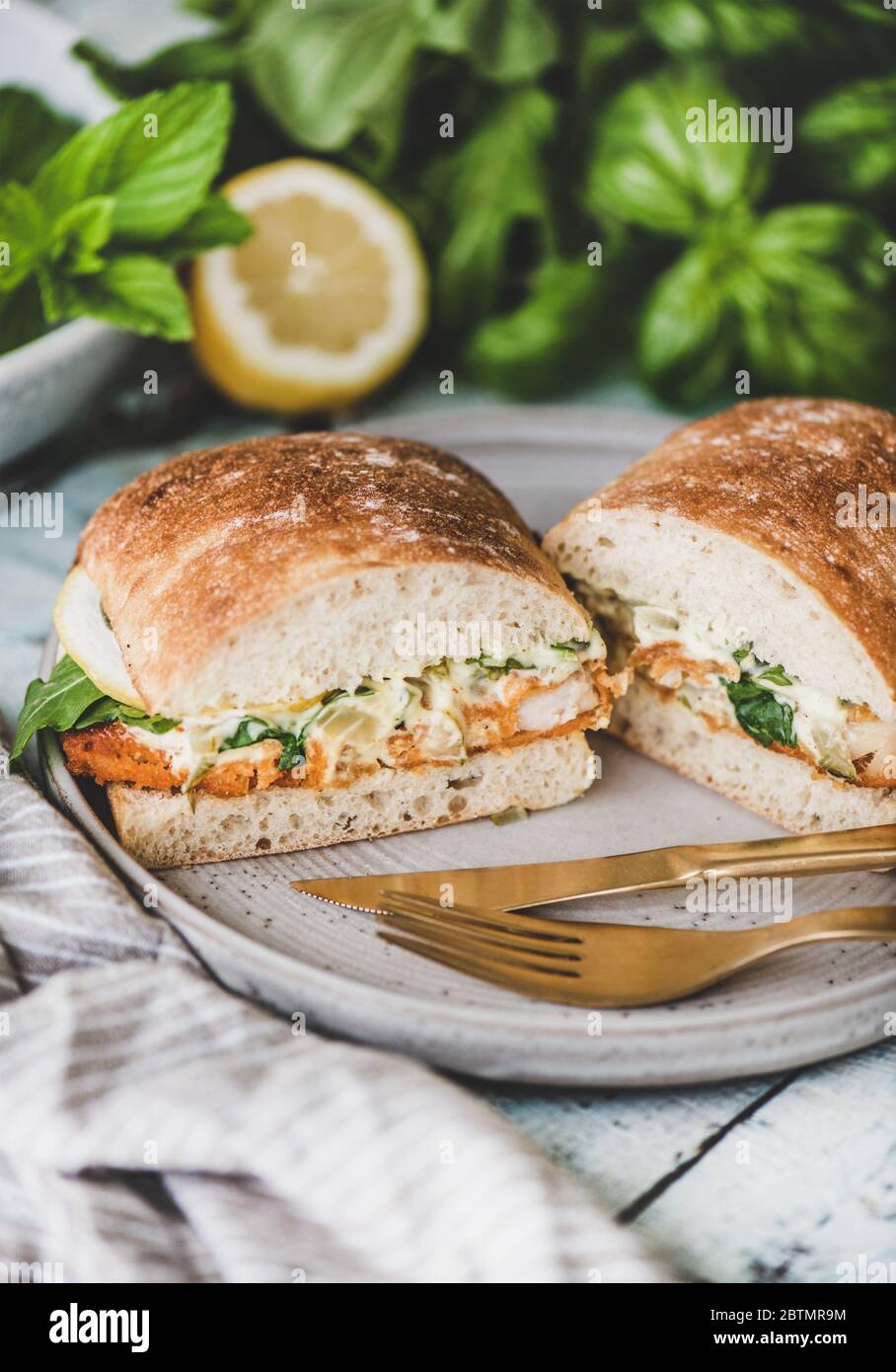 Breakfast with fish sandwich filled with lemon and greens Stock Photo ...