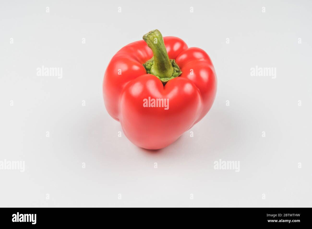 Ripe red pepper on a light background Stock Photo - Alamy