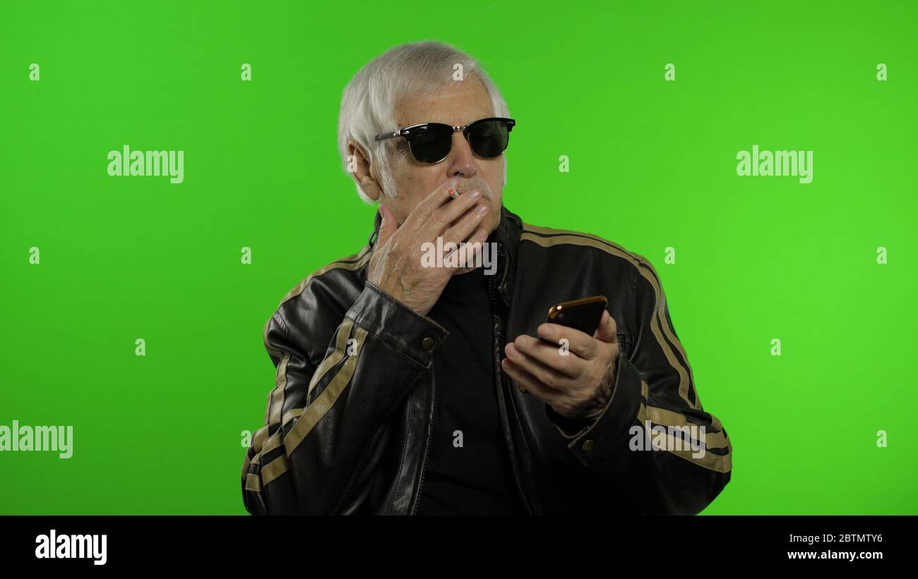 Elderly stylish grandfather caucasian mature rocker and biker man using ...