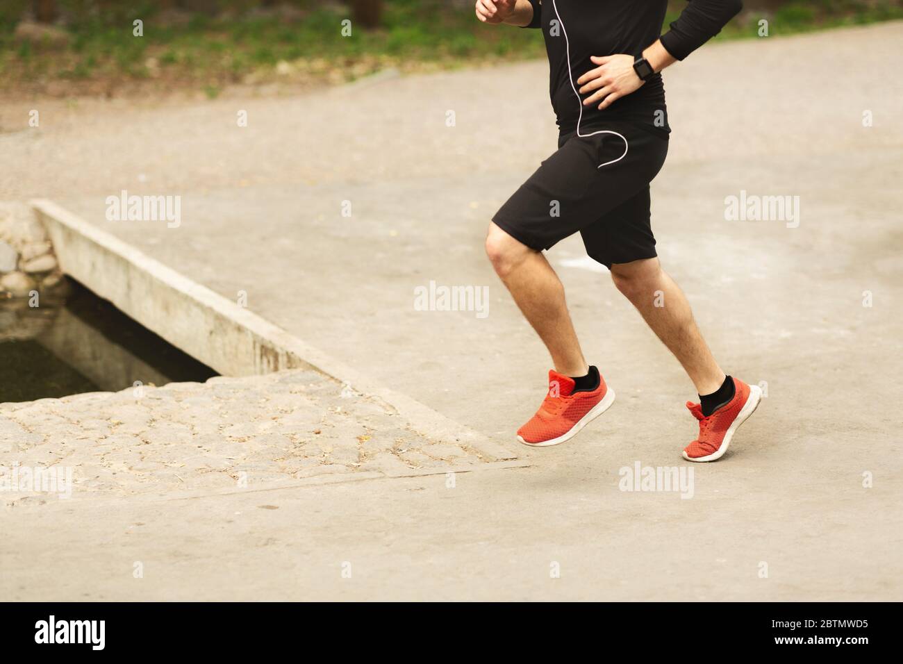 Man running in the park, side view of legs Stock Photo - Alamy