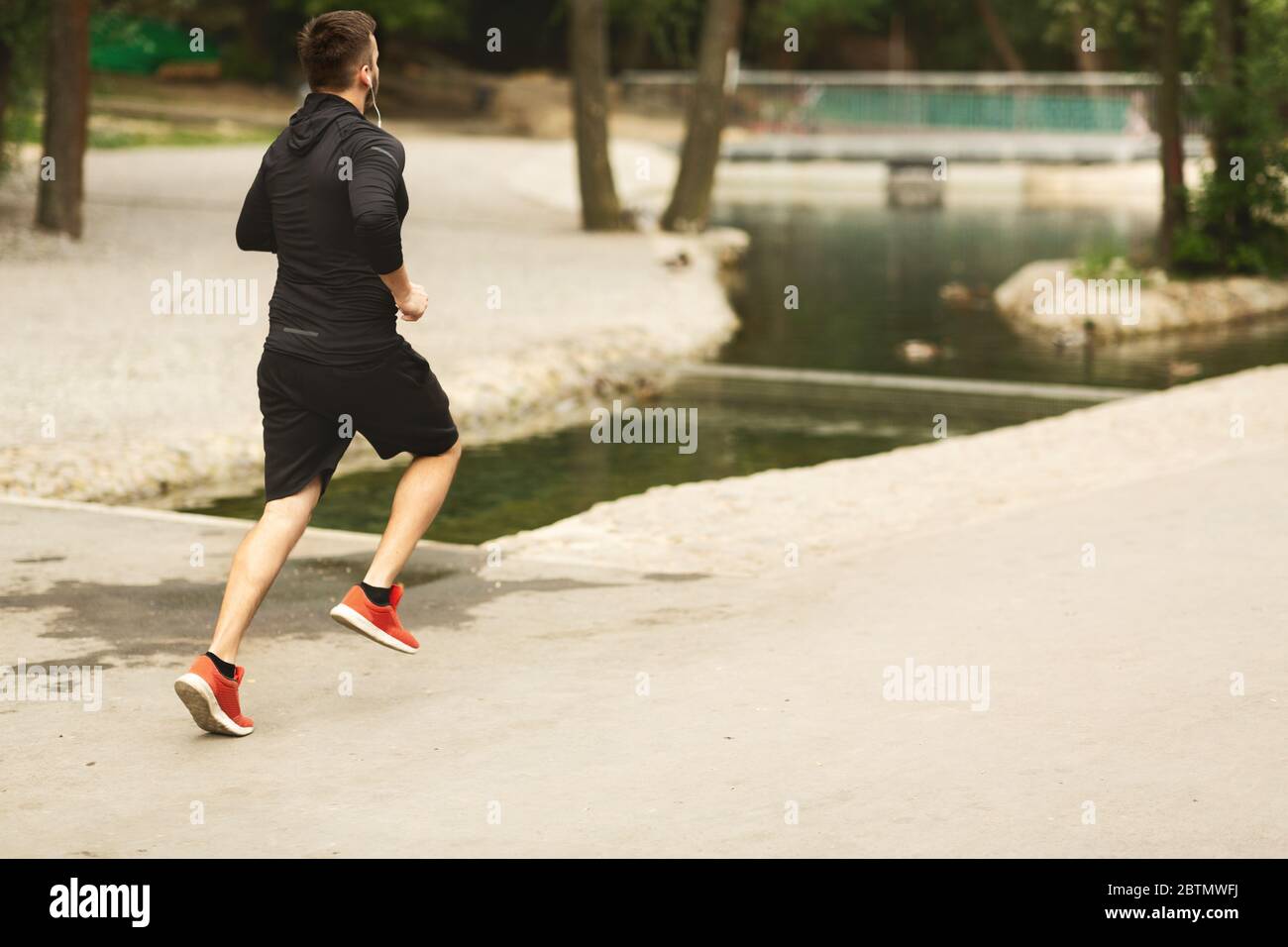 Fitness sporty man running in the park Stock Photo - Alamy