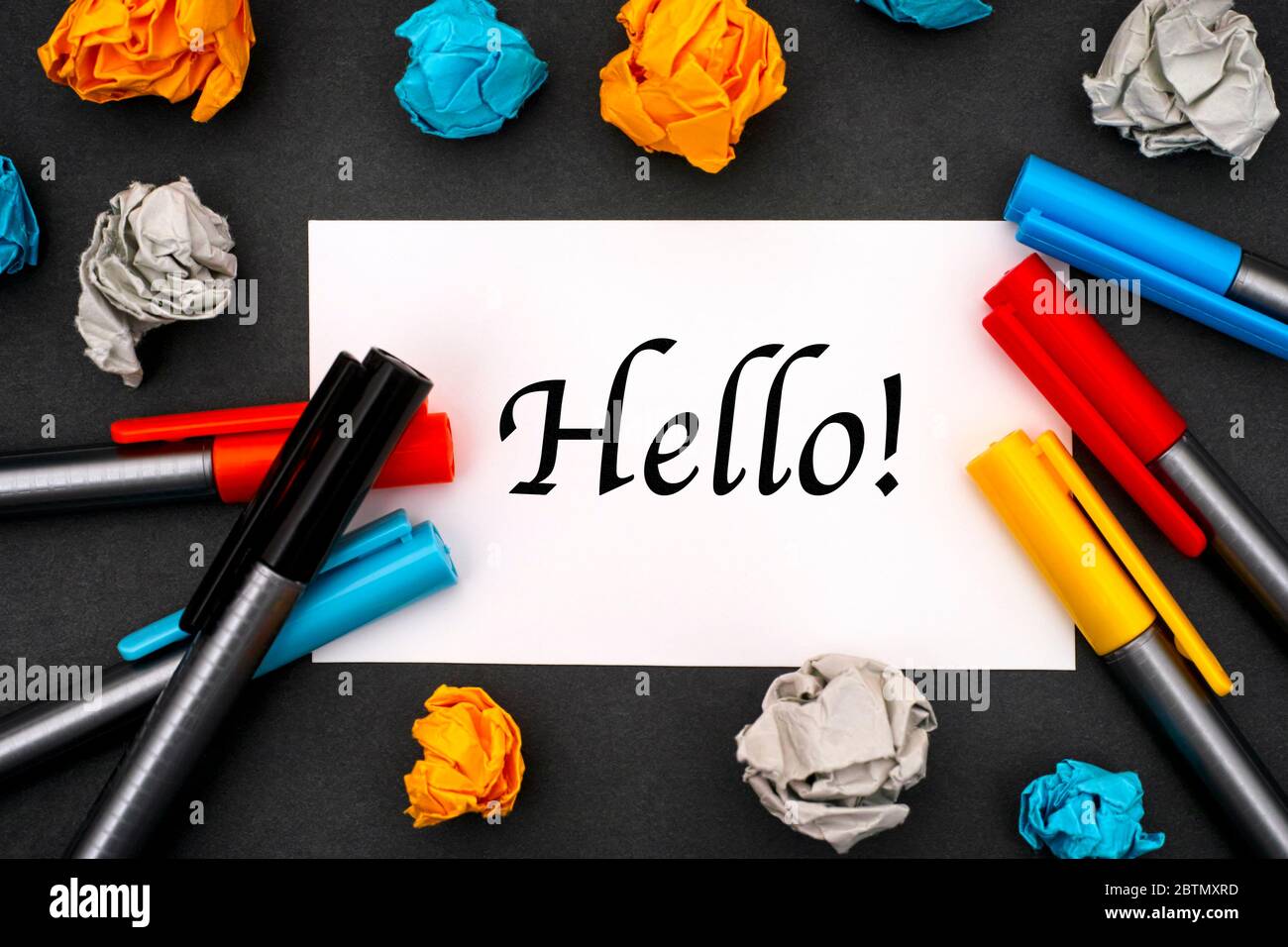 Word Hello on paper blank with colour pens and crumpled paper. Black ...