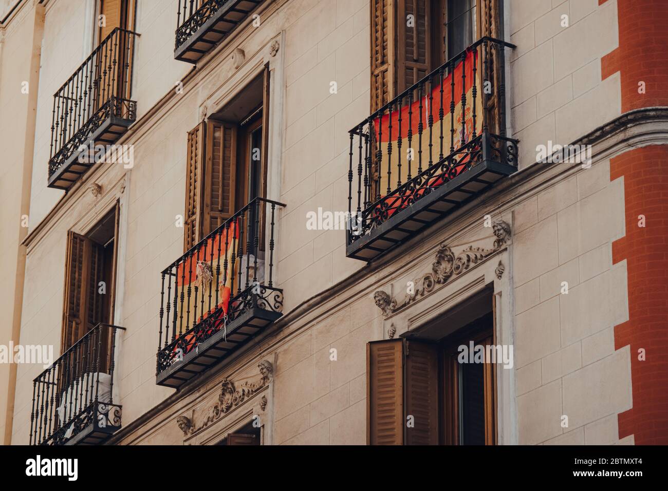 Spanish flags handing on balcony railings of a building in Madrid ...