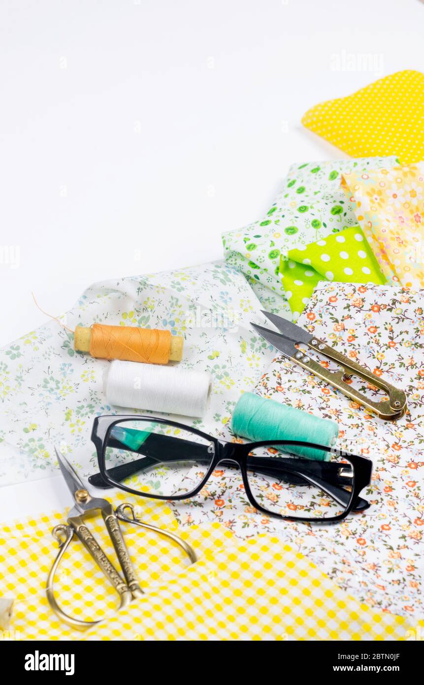 Sewing set with fabric, spools of thread, scissors and glasses Stock ...