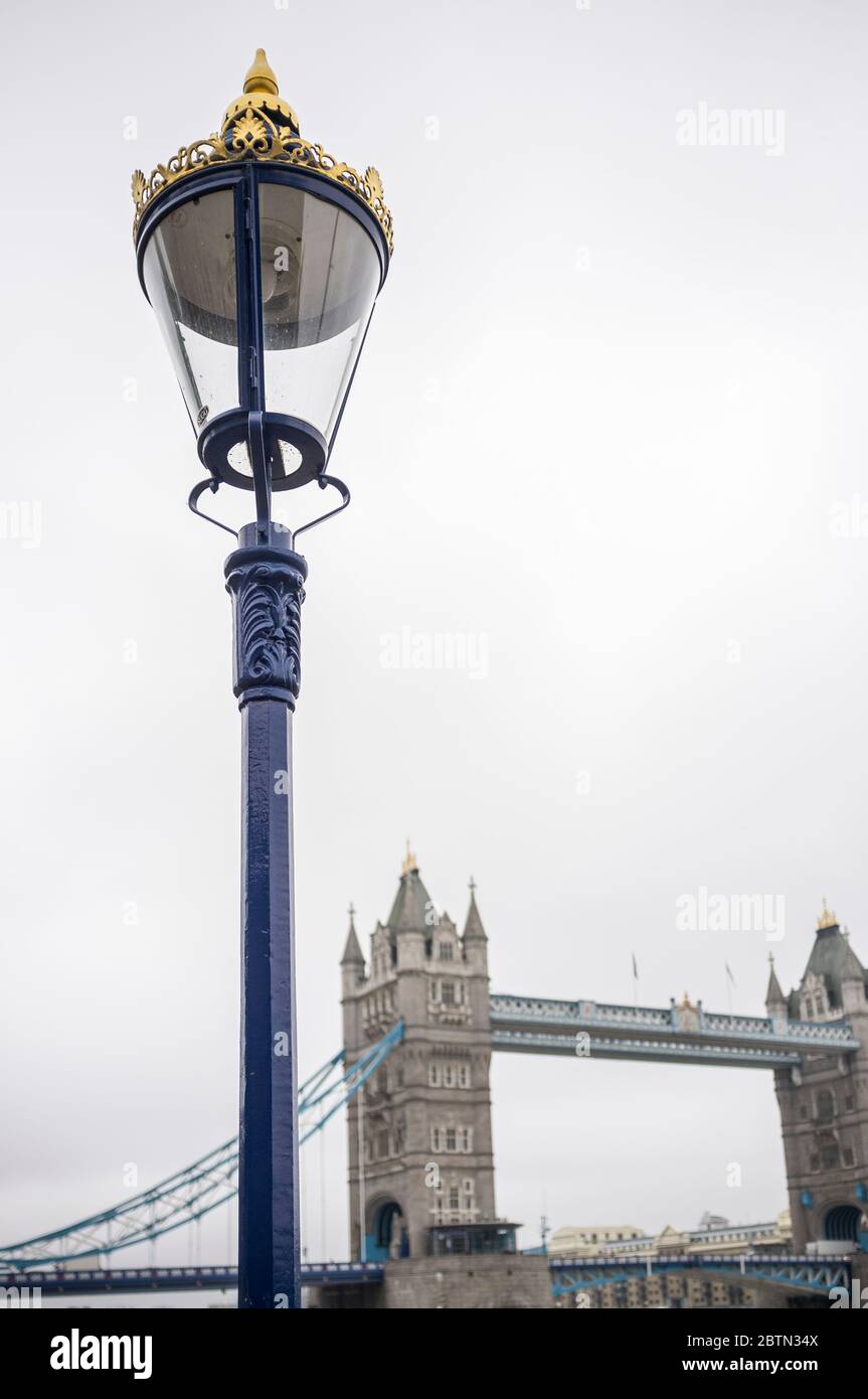 Traditional street light with Tower Bridge in the background, on a dull ...