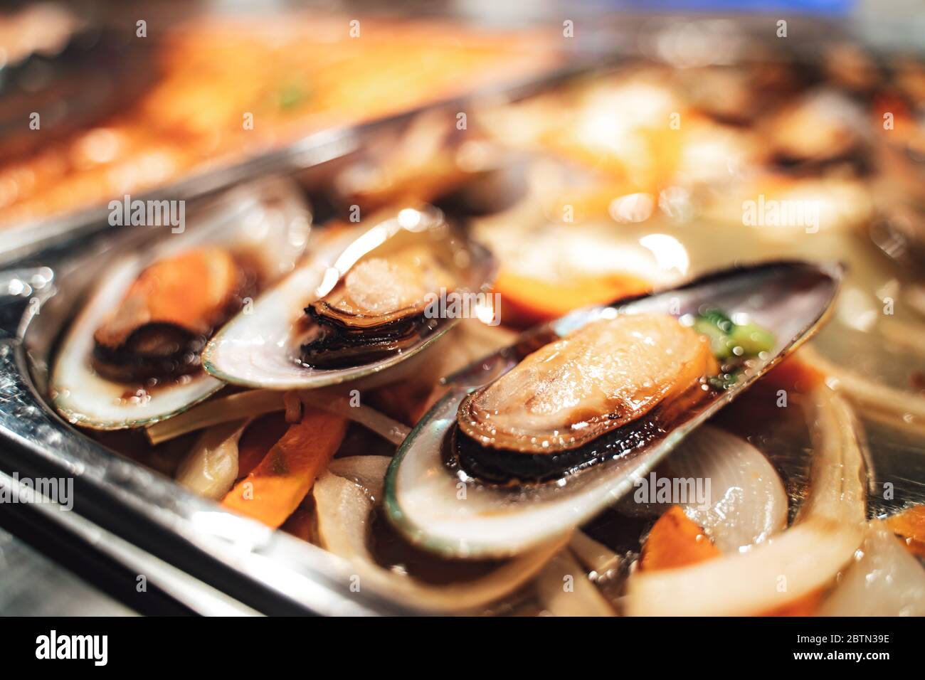 Gourmet cooked mussels on a bed of vegetables Stock Photo - Alamy