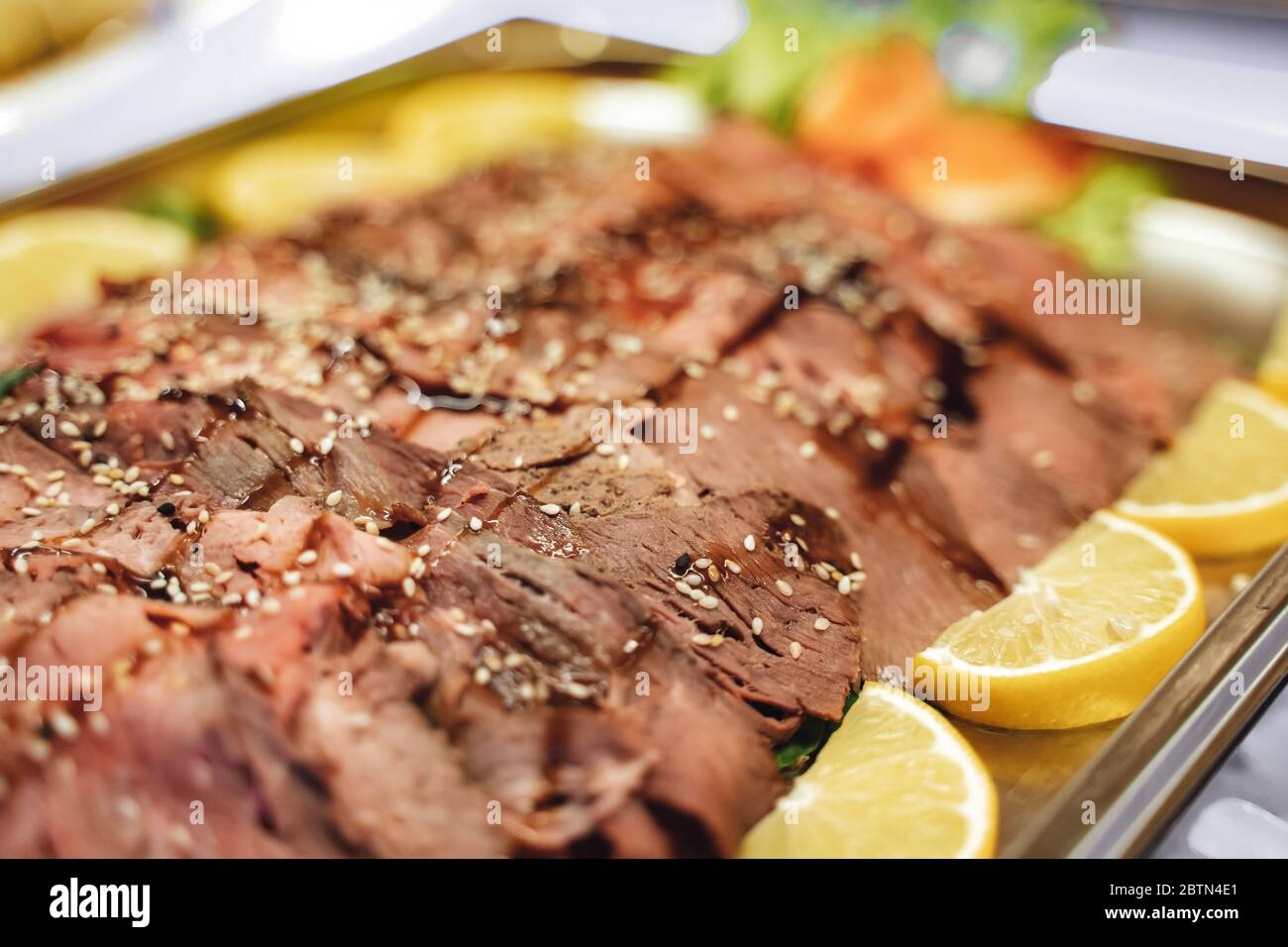 Sliced seasoned roast beef on a buffet table Stock Photo - Alamy
