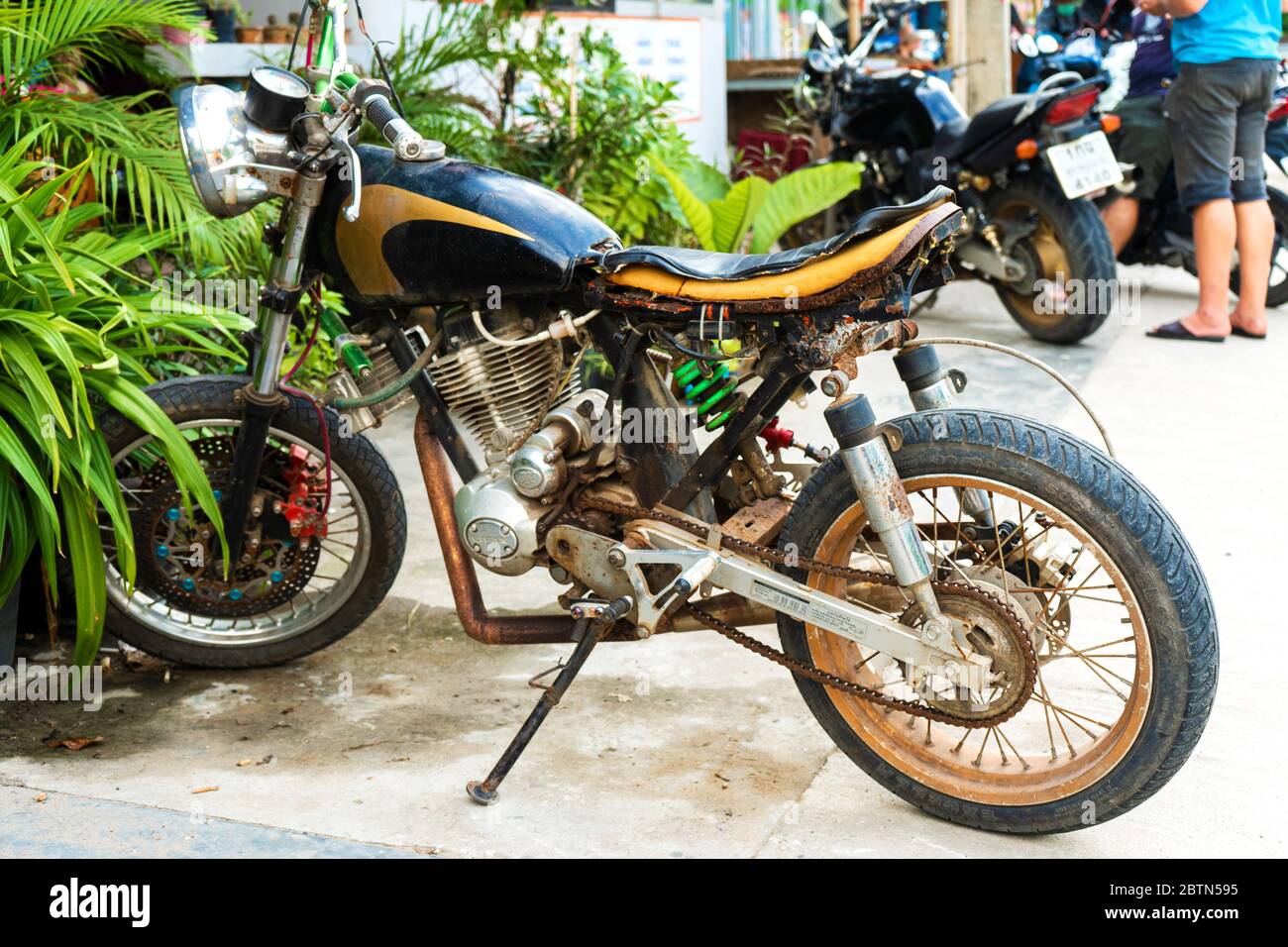 Old rusty motorcycle. typical vehicle in Asia. A crumbling motorcycle ...