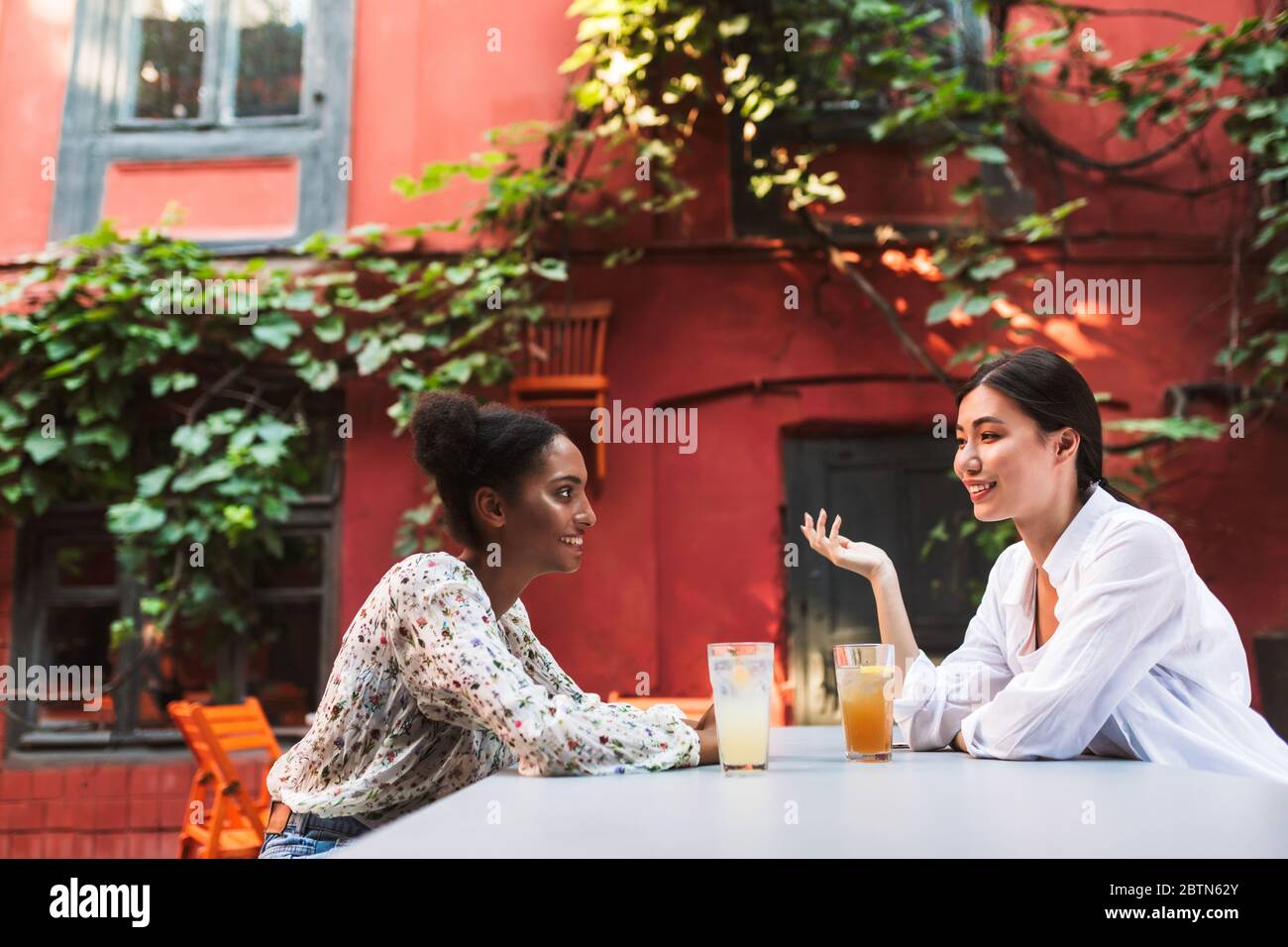 Two girls talking meeting hi-res stock photography and images - Alamy