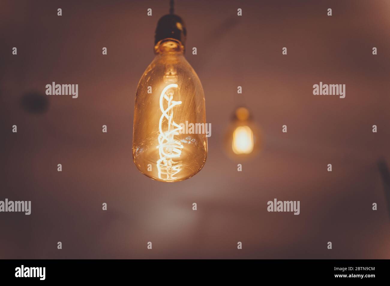 Light bulbs on the ceiling in the bar and restaurant. Italian cafe with ...