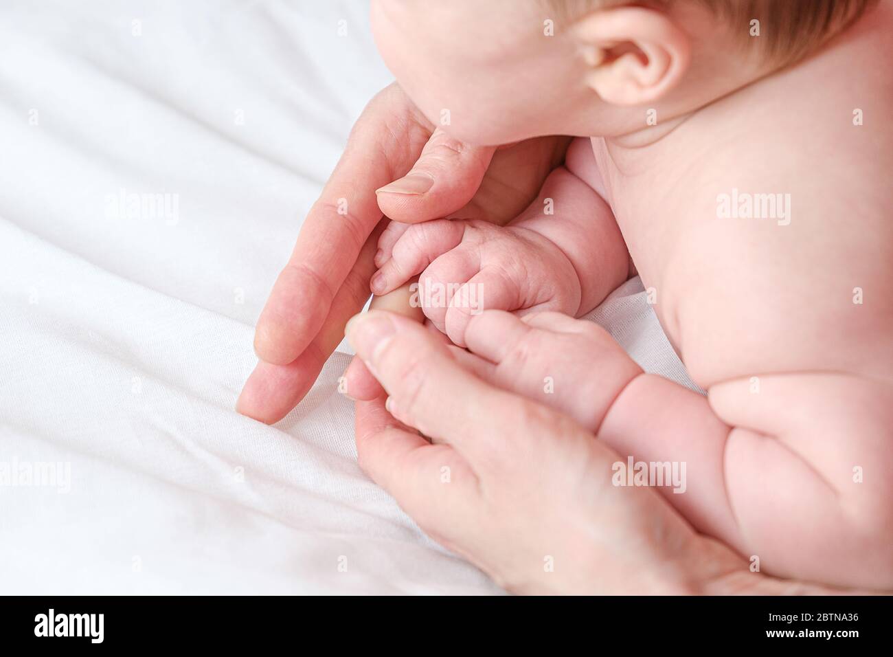 baby foot in mom's hands. massage concept for babies. The feet of a ...