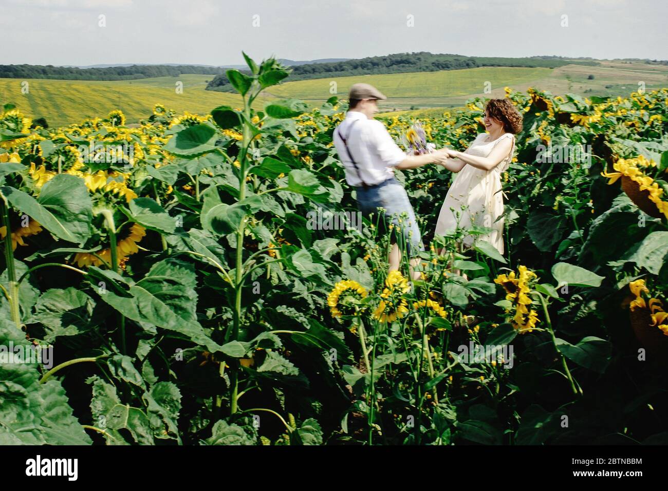 Romantic couple dancing in sunflower hi-res stock photography and ...