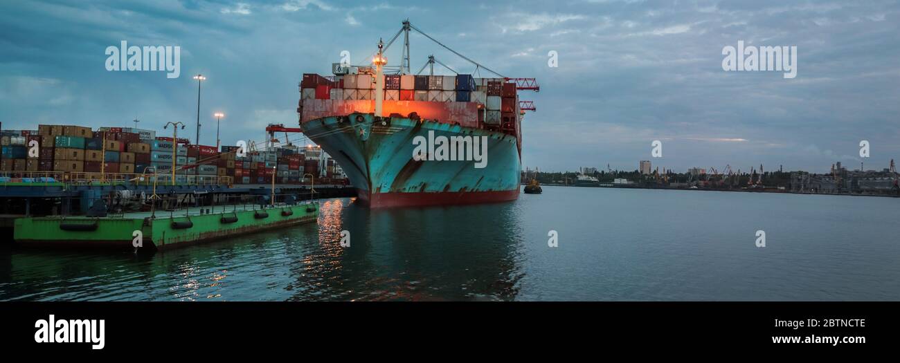 Container cargo ship load in the seaport at dusk. Logistics and ...
