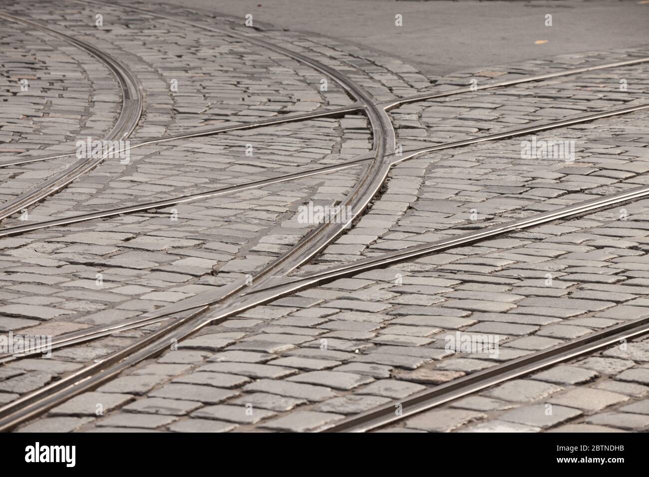 Close up on a tramway rail switch on a cobblestone pavement on an old ...