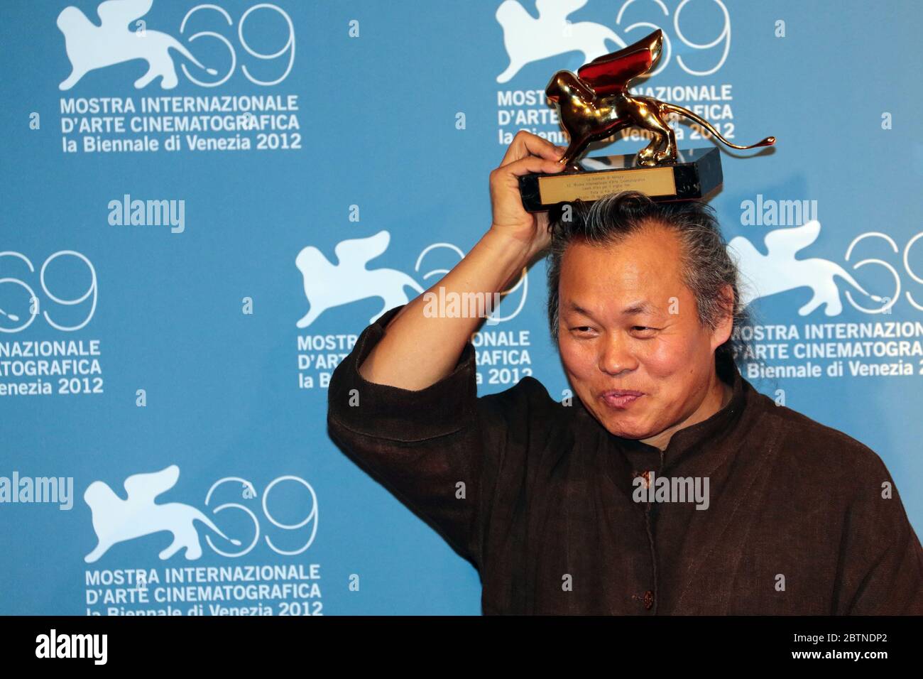 VENICE, ITALY - SEPTEMBER 08: Kim Ki-Duk poses with the Golden Lion for ...